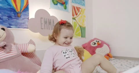 The little girl is playing on bed in the... | Stock Video | Pond5