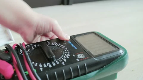 Little girl playing with a multimeter | Stock Video | Pond5