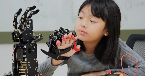 Little Girl is playing with robotic arm ... | Stock Video | Pond5