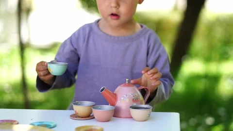 Little girl playing tea party with toy c... | Stock Video | Pond5