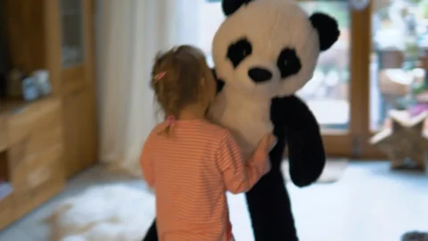 Little girl is playing with toy Panda be... | Stock Video | Pond5