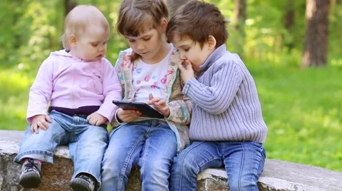 Little girl plays with tablet PC, boy an... | Stock Video | Pond5