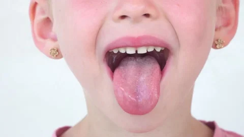 Little girl plays with tongue and saliva... | Stock Video | Pond5