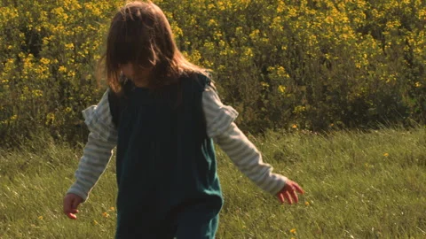 Little girl pretend to fly in circles on... | Stock Video | Pond5