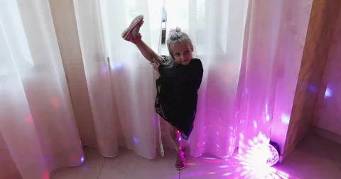 Little girl raises her leg up. Beautiful... | Stock Video | Pond5