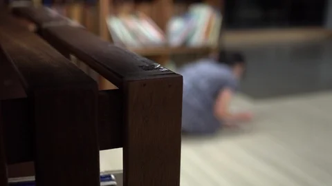 Little girl is reading in the library. T... | Stock Video | Pond5