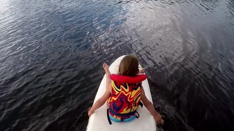 A little girl with a red life jacket sit... | Stock Video | Pond5