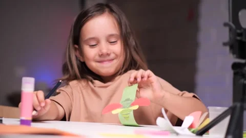 a little girl shows her paper craft lady... | Stock Video | Pond5