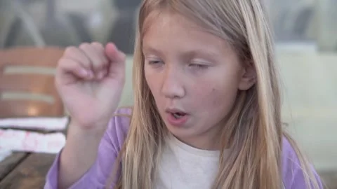Little girl shows her tongue and makes d... | Stock Video | Pond5