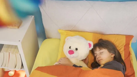 Little girl sleeping in her bed with her... | Stock Video | Pond5