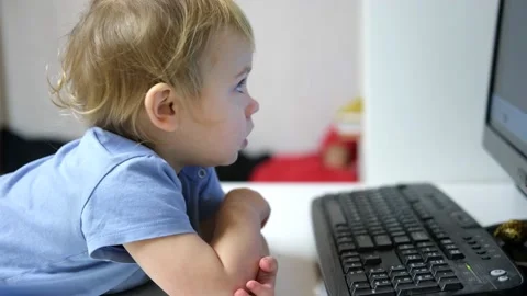 Little girl Stares Intently at the Monit... | Stock Video | Pond5