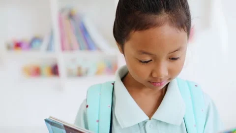 Little girl staring at camera with glare... | Stock Video | Pond5