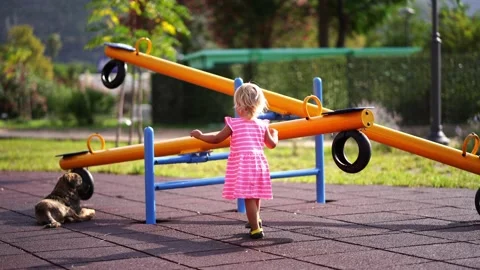 Little girl swings a swing-balancer stan... | Stock Video | Pond5