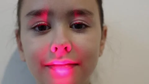 Little girl treating nose with infrared ... | Stock Video | Pond5