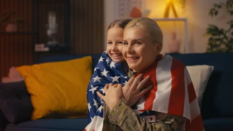 Little girl with a U.S. flag hugs her mi... | Stock Video | Pond5