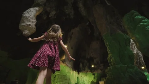 Little girl walking in a cave. Steadicam... | Stock Video | Pond5