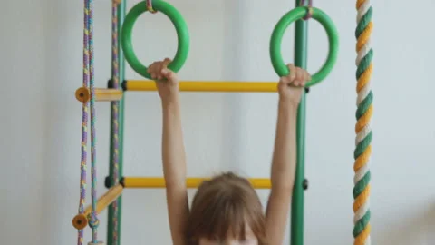 Little girl on wall bars | Stock Video | Pond5