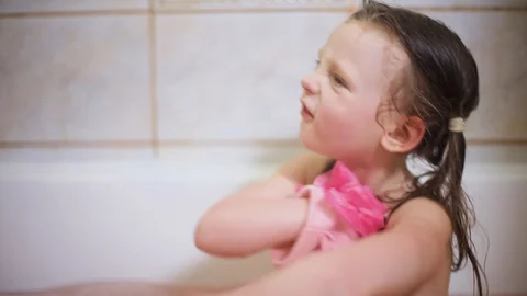 The little girl is washed in the bathroo... | Stock Video | Pond5