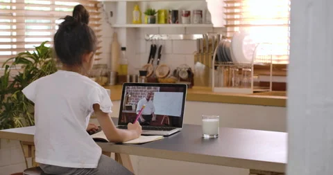 Little girl watching lesson online and s... | Stock Video | Pond5