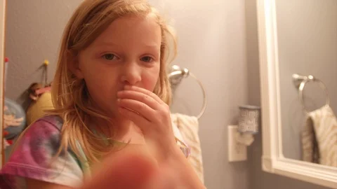 A little girl who lost a tooth holds her... | Stock Video | Pond5
