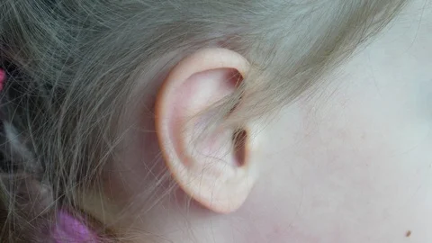 Little girl wiggles her ear in close-up.... | Stock Video | Pond5
