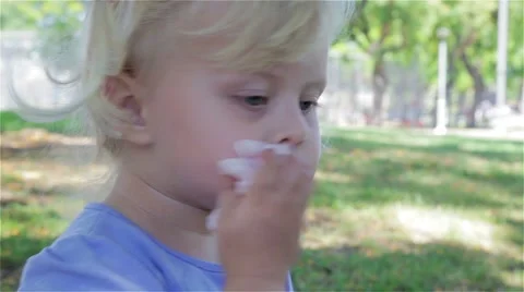 Little girl wiping his face with a napki... | Stock Video | Pond5