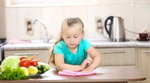 Little girl wiping the table | Stock Video | Pond5