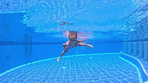 Little girls, sisters, triplets swim in ... | Stock Video | Pond5