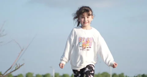 A Little Girl's Spirited Dance with Natu... | Stock Video | Pond5