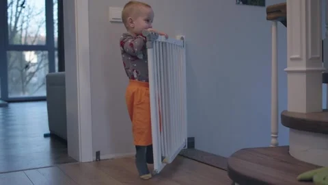 little kid boy riding home security gate... | Stock Video | Pond5