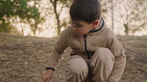 Little kid boy standing playing alone on... | Stock Video | Pond5