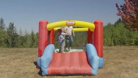 Little Kids Jumping On Bounce House | Stock Video | Pond5