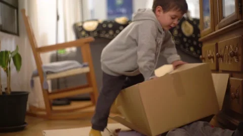 Little kids playing with moving boxes | Stock Video | Pond5