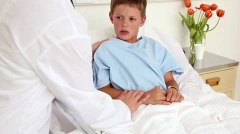 Little sick boy sitting in bed talking w... | Stock Video | Pond5