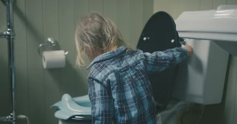 Little toddler potty training and flushi... | Stock Video | Pond5