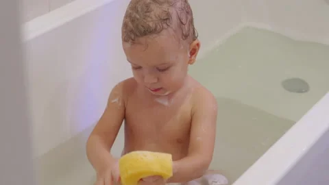 Little toddler taking bath child playing... | Stock Video | Pond5