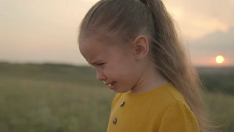 a little upset child is crying at sunset... | Stock Video | Pond5