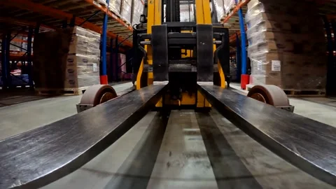The load lifter rides on the warehouse p... | Stock Video | Pond5