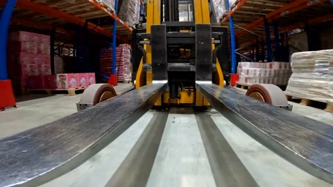The load lifter rides on the warehouse p... | Stock Video | Pond5
