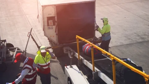 Loading baggage into airliner's cargo ho... | Stock Video | Pond5