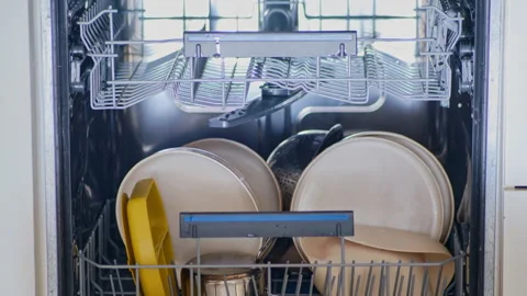 Loading dirty dishes into the dishwasher... | Stock Video | Pond5