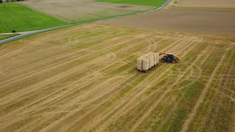 Loading Hay Bales on a Trailer | JCB For... | Stock Video | Pond5