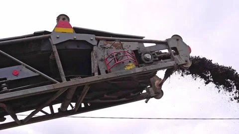 loading of old cut asphalt by elevator i... | Stock Video | Pond5