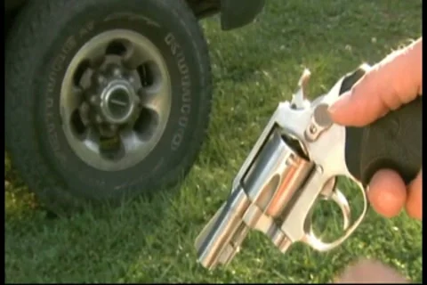Loading one bullet into pistol revolver | Stock Video | Pond5