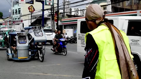Local traffic enforcers directing vehicl... | Stock Video | Pond5