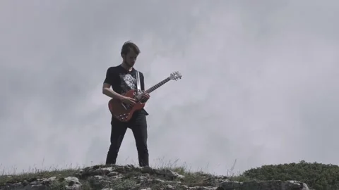 Locked down shot, a rocker man plays gui... | Stock Video | Pond5