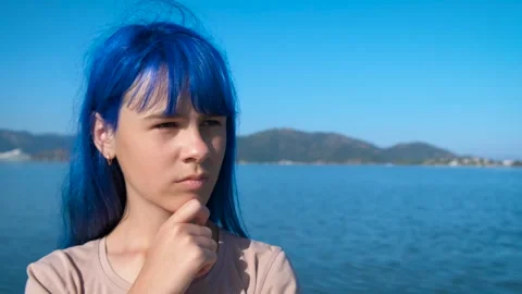 Lonely blue teen on sea background. | Stock Video | Pond5