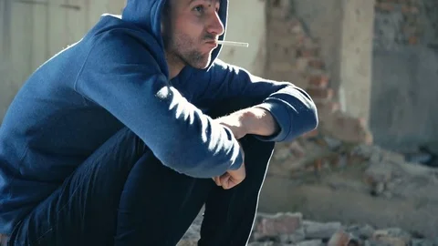 Lonely junkie smoking cigarette in catac... | Stock Video | Pond5
