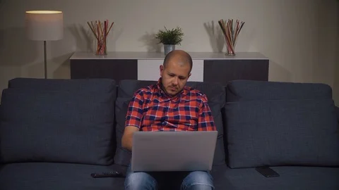lonely sad man on sofa closing his pc an... | Stock Video | Pond5