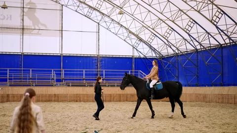 Long-haired woman riding a beautiful bla... | Stock Video | Pond5